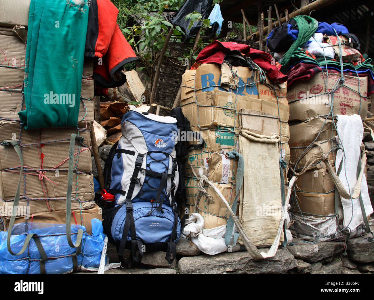 a trekkers backpacker between the huge loads of the Nepali Sherpas ...
