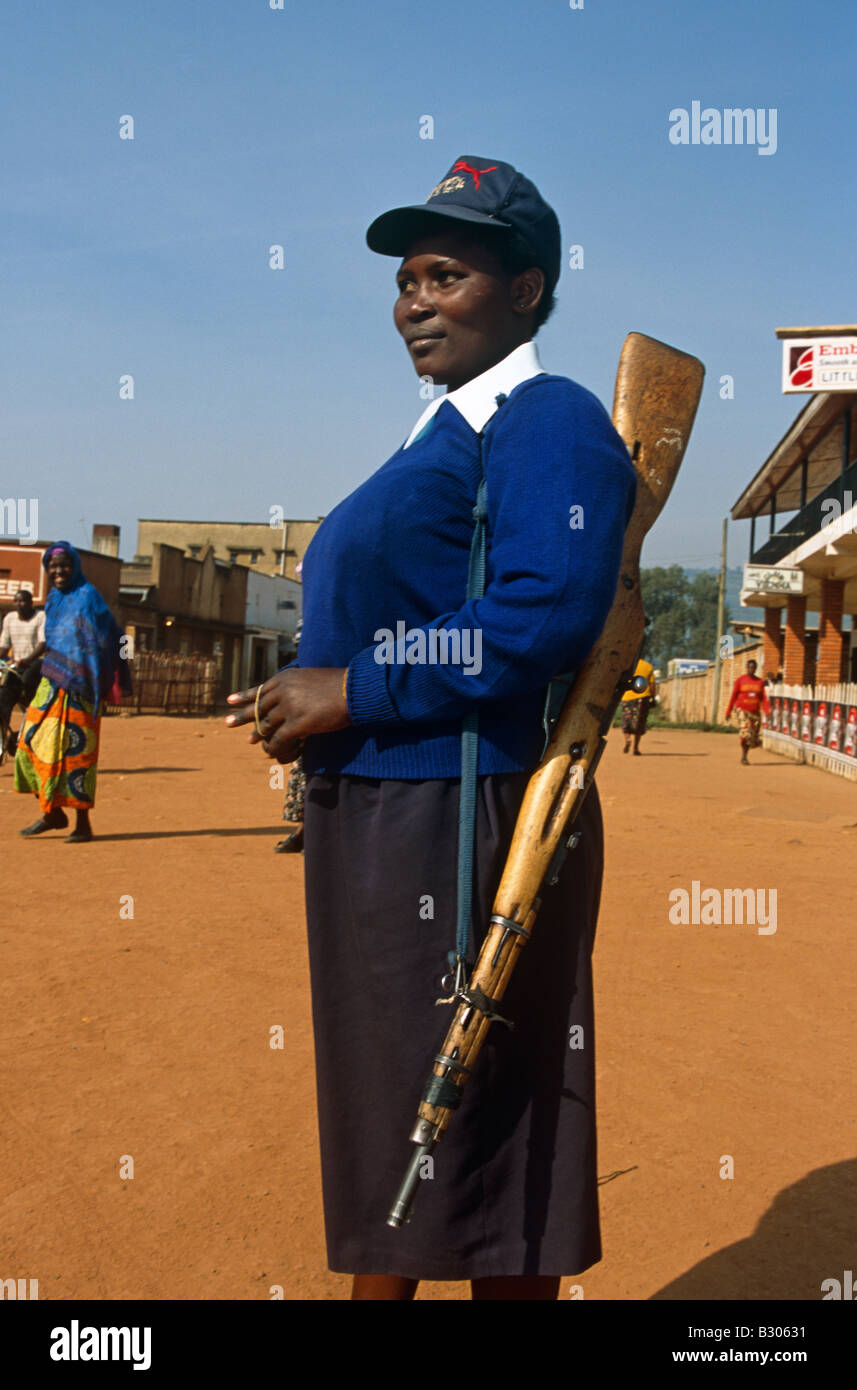 Uniformed female security guard on street carrying firearm, Uganda ...