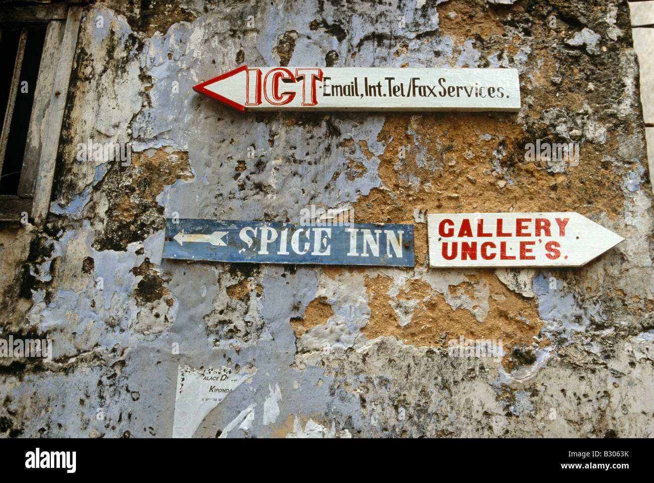 Signs for restaurants and services on dilapidated old wall. Old Town ...