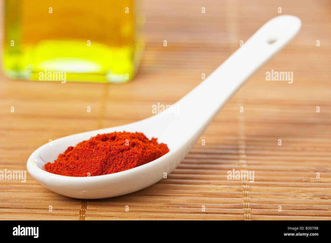 Paprika in the spoon and oil bottle for prepare tasty food with soft ...