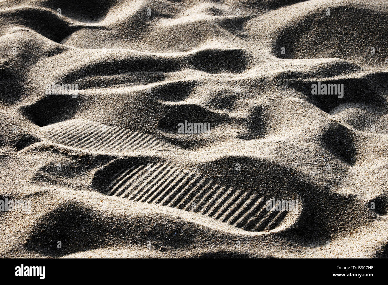 many footprints on a sand beach Stock Photo - Alamy
