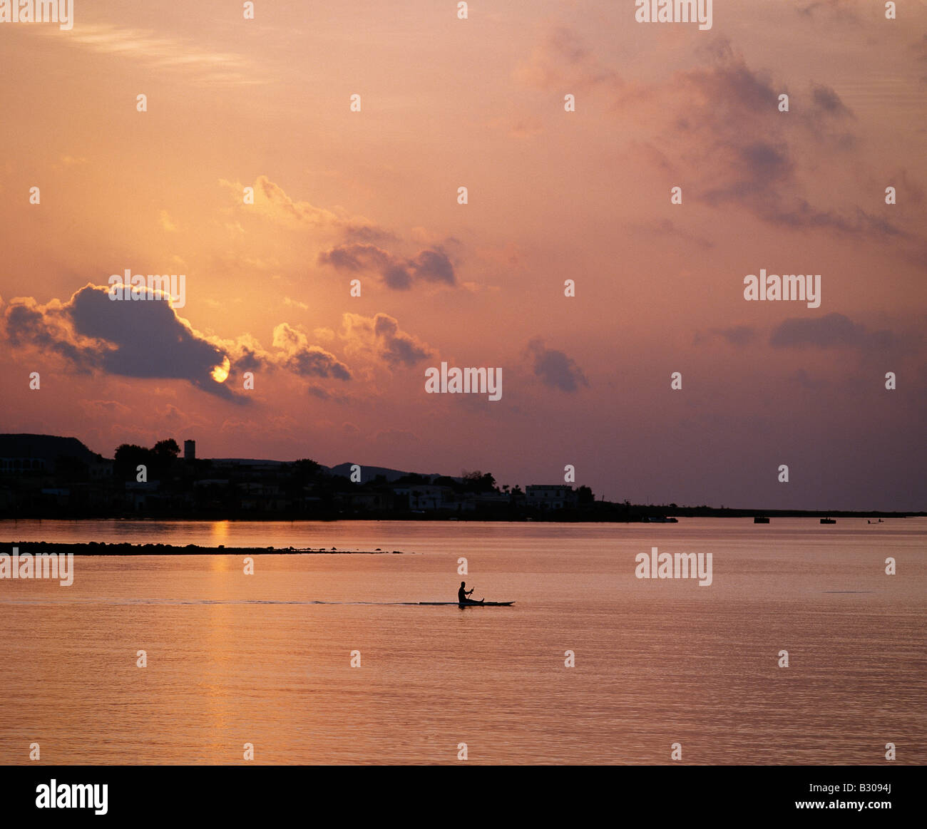 Djibouti, Tadjoura. A fishermen paddles his small boat across Tadjoura ...