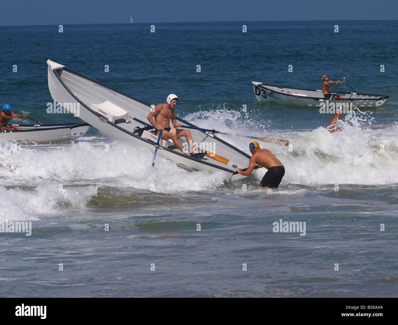 Competitor gets an assist rowing surfboat through the waves at the ...