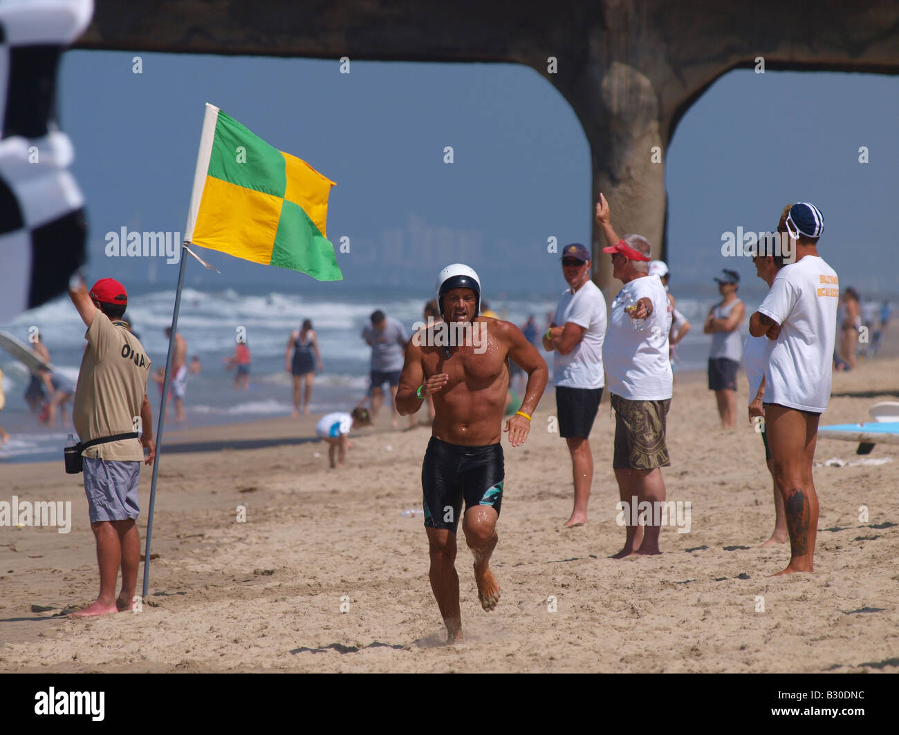 Lifeguard competitor races up the beach Stock Photo - Alamy
