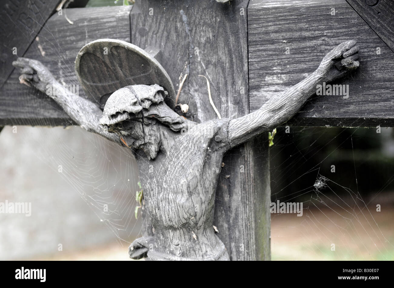 a statue of jesus christ on the cross made of wood on a grave Stock ...