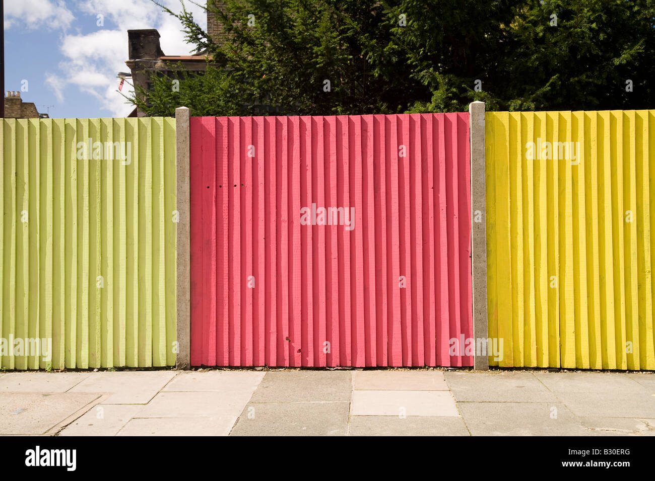 Bright colourful painted fence in sunshine Stock Photo - Alamy