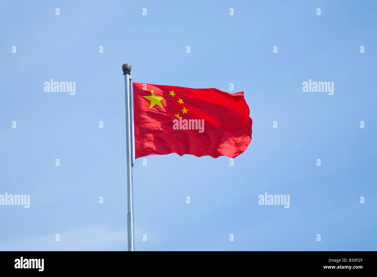Chinese flag against blue sky Stock Photo - Alamy