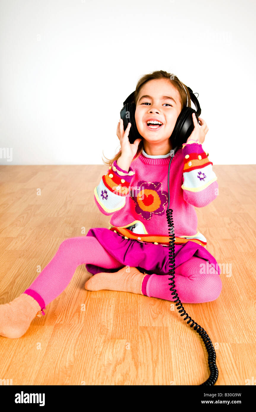 adorable little girl listening to music with headphones Stock Photo - Alamy
