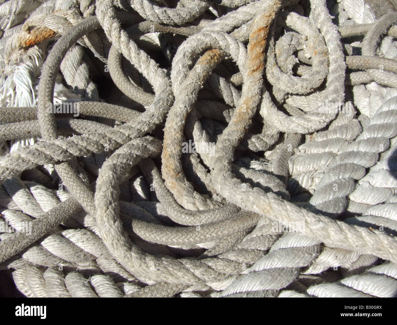 detail tangled bundle of ropes on floor in port Stock Photo - Alamy