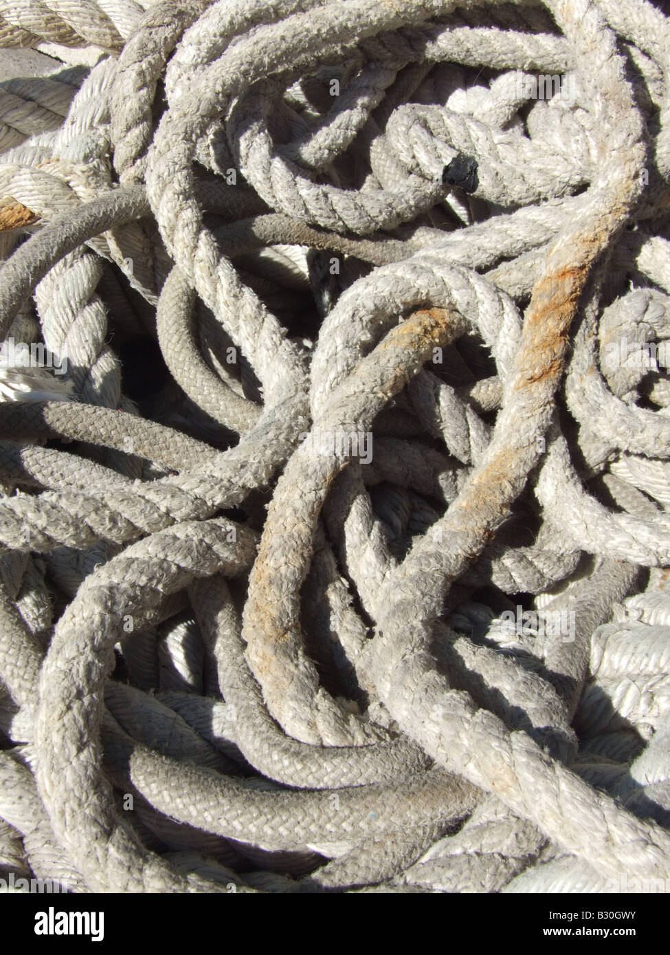 detail tangled bundle of ropes on floor in port Stock Photo - Alamy