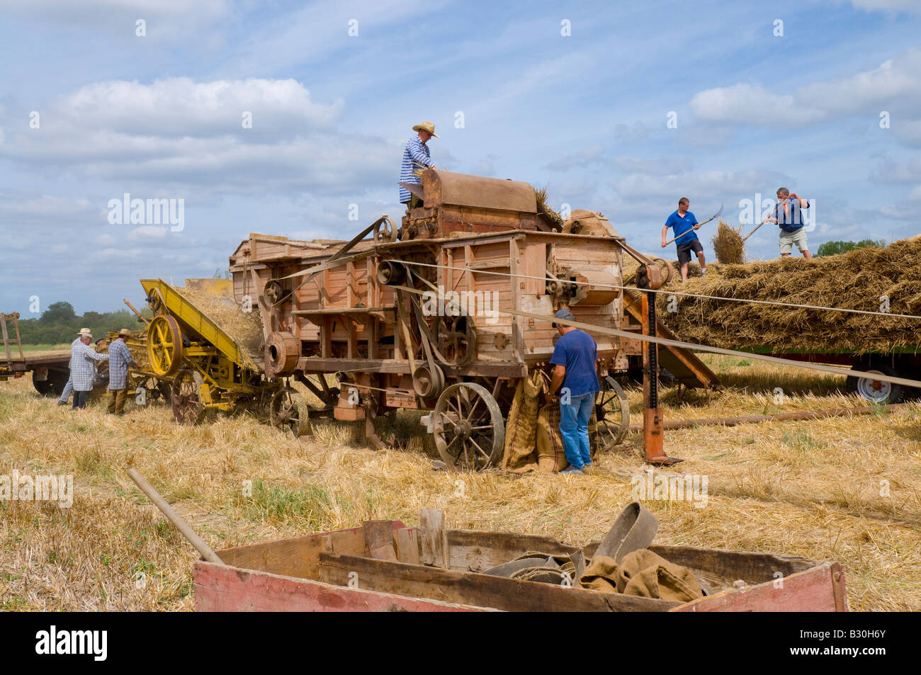 French farmers working threshing machine at agricultural show, Indre ...