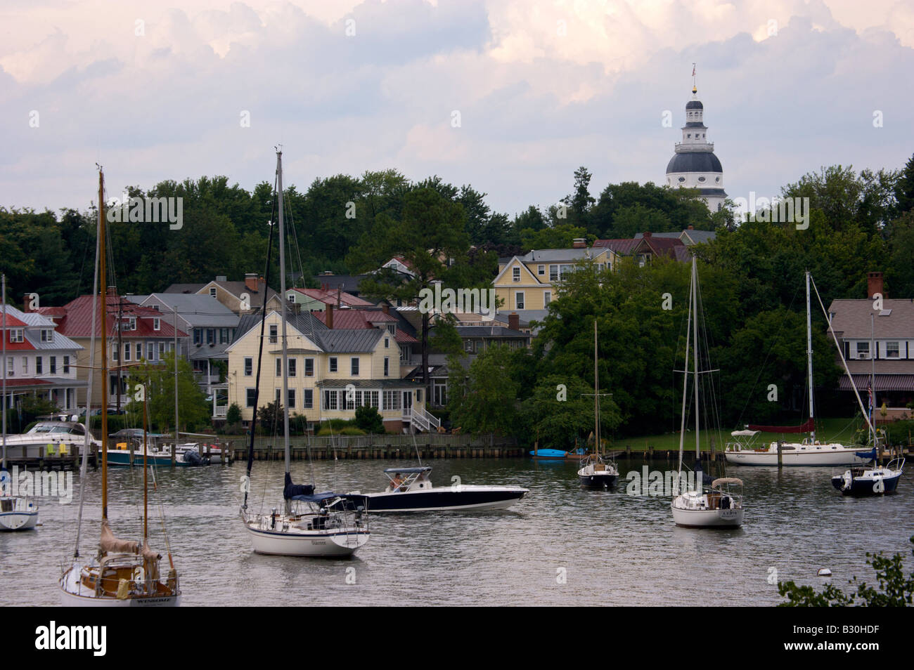 Sailboats moored along the Annapolis waterfront with the historic state ...