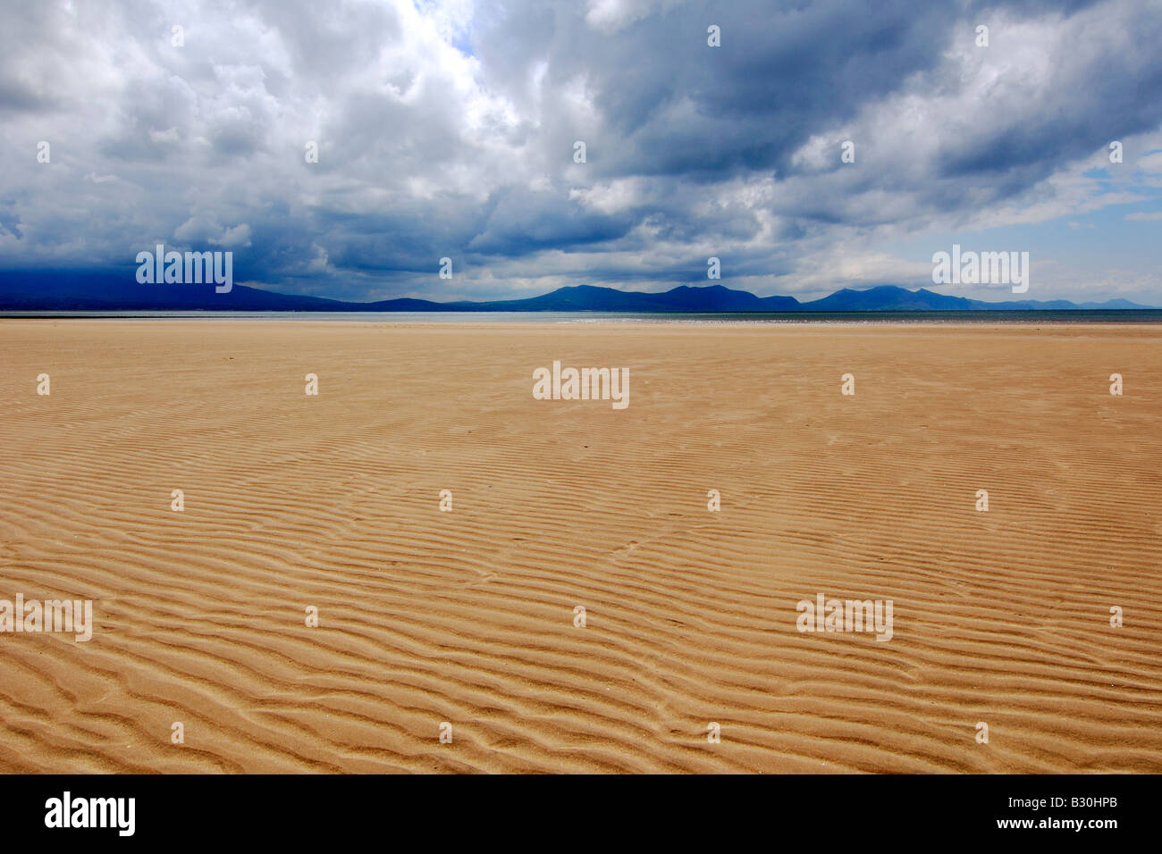 A wide expanse of flat sandy beach at Newborough Warren on Anglesey ...