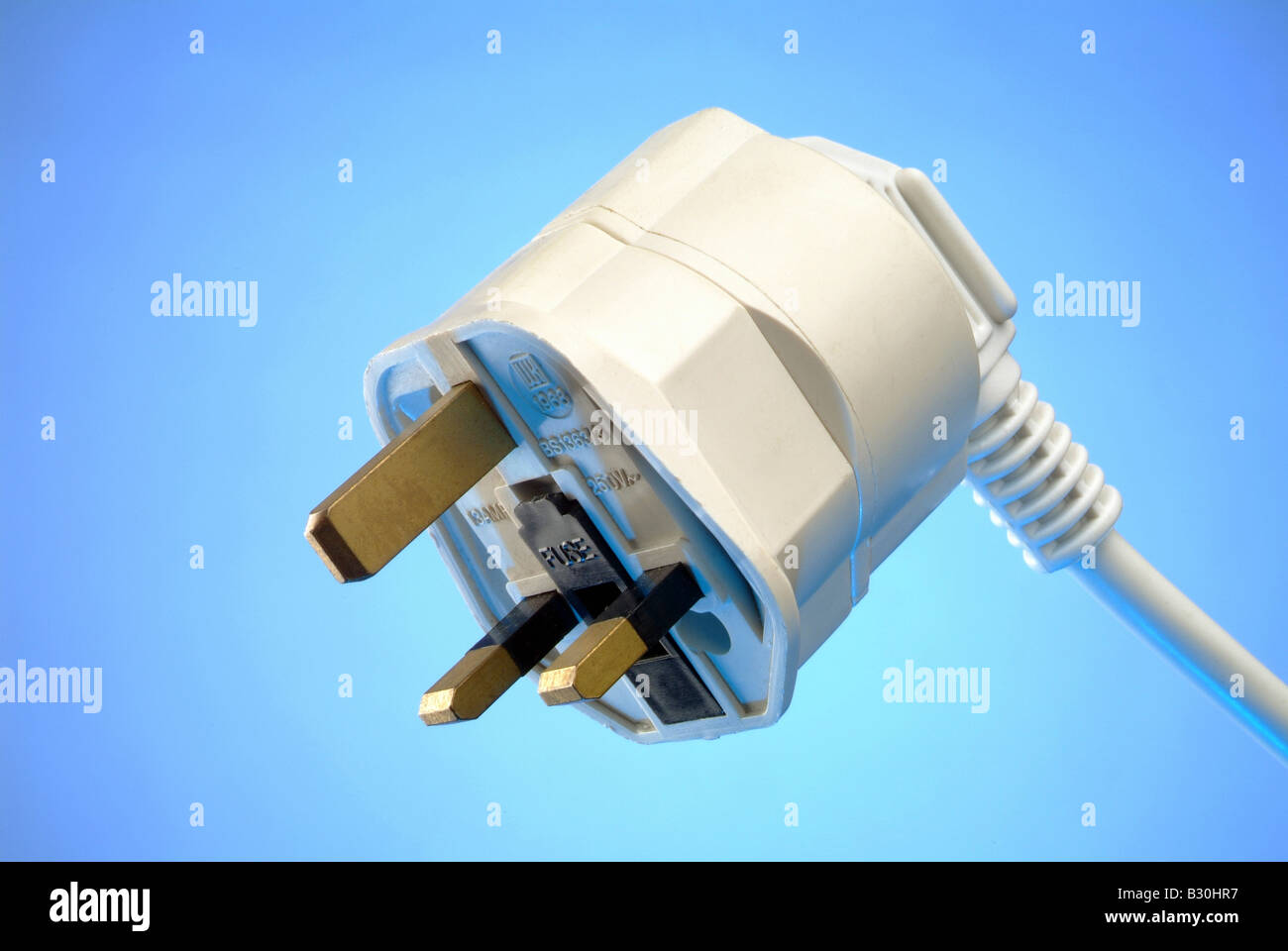 White plug on blue background Stock Photo - Alamy