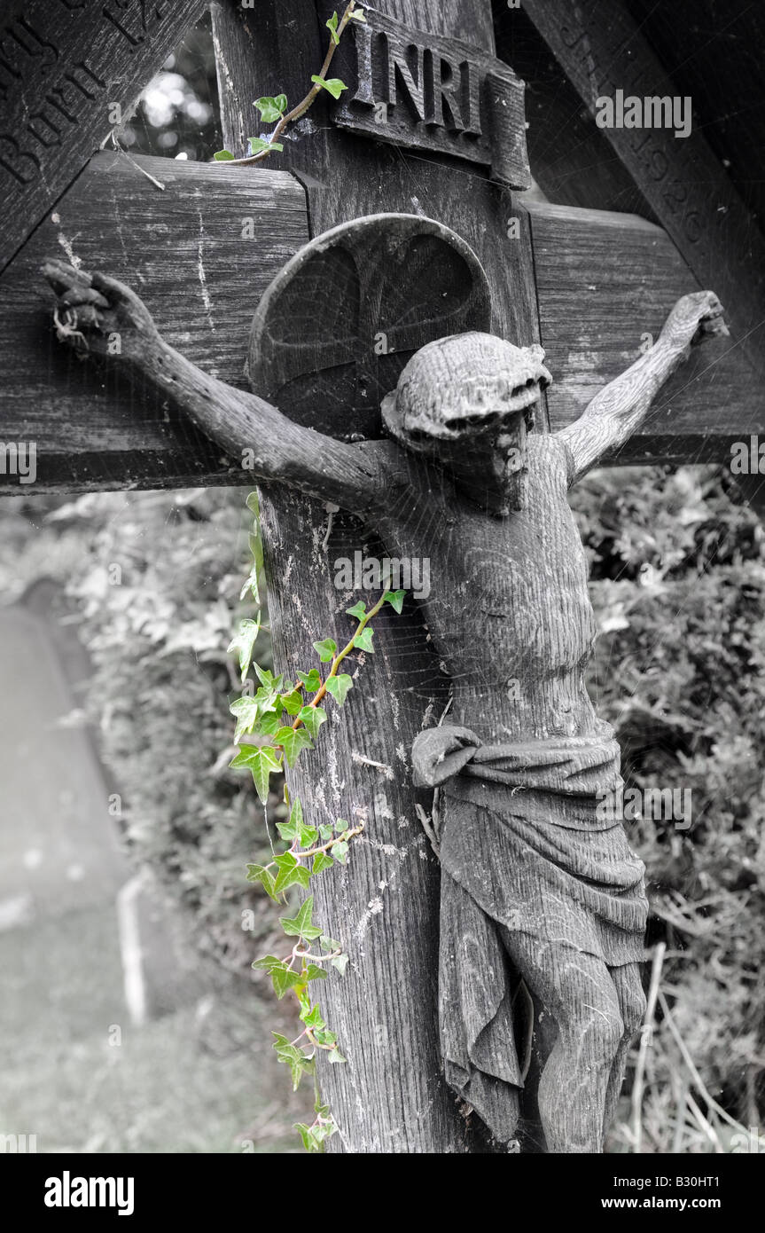 a statue of jesus christ on the cross made of wood on a grave Stock ...