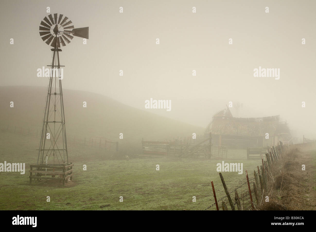 Fence windmill barn fog green grass hi-res stock photography and images ...