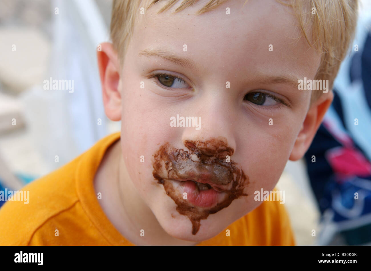 A young boy after eating a chocolate ice cream Stock Photo - Alamy