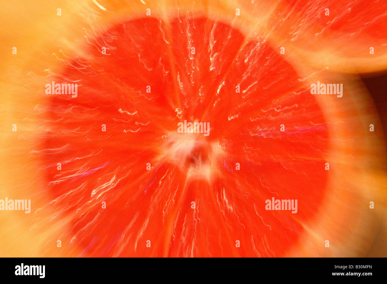 A zoom of a brightly-colored juicy pink sliced grapefruit Stock Photo ...