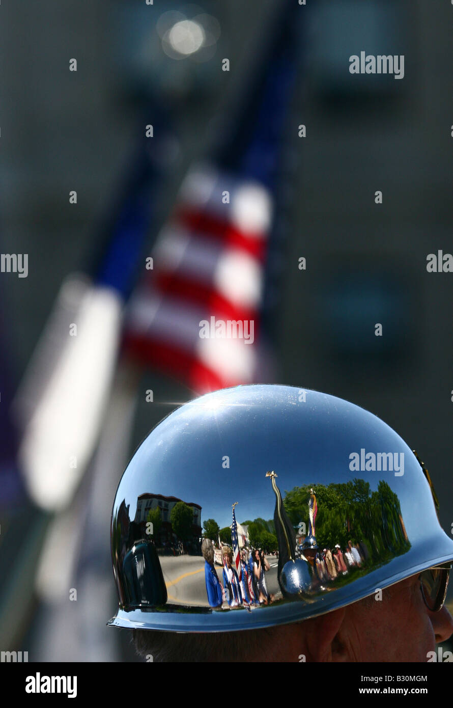 A crowd is reflected in the shiny helmet of a soldier during a Memorial ...