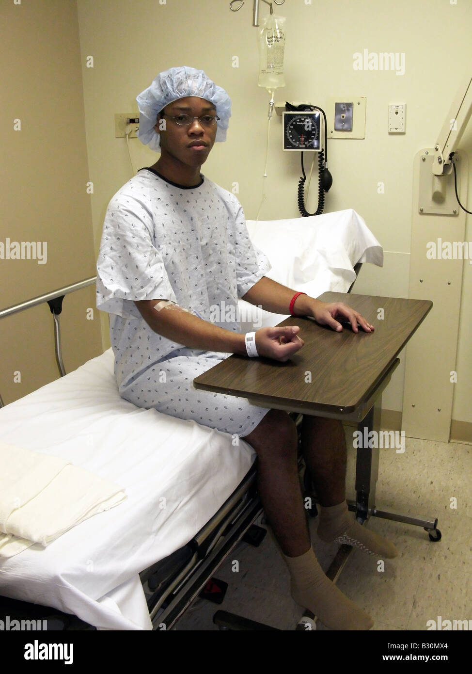 black male sitting on hospital bed Stock Photo - Alamy