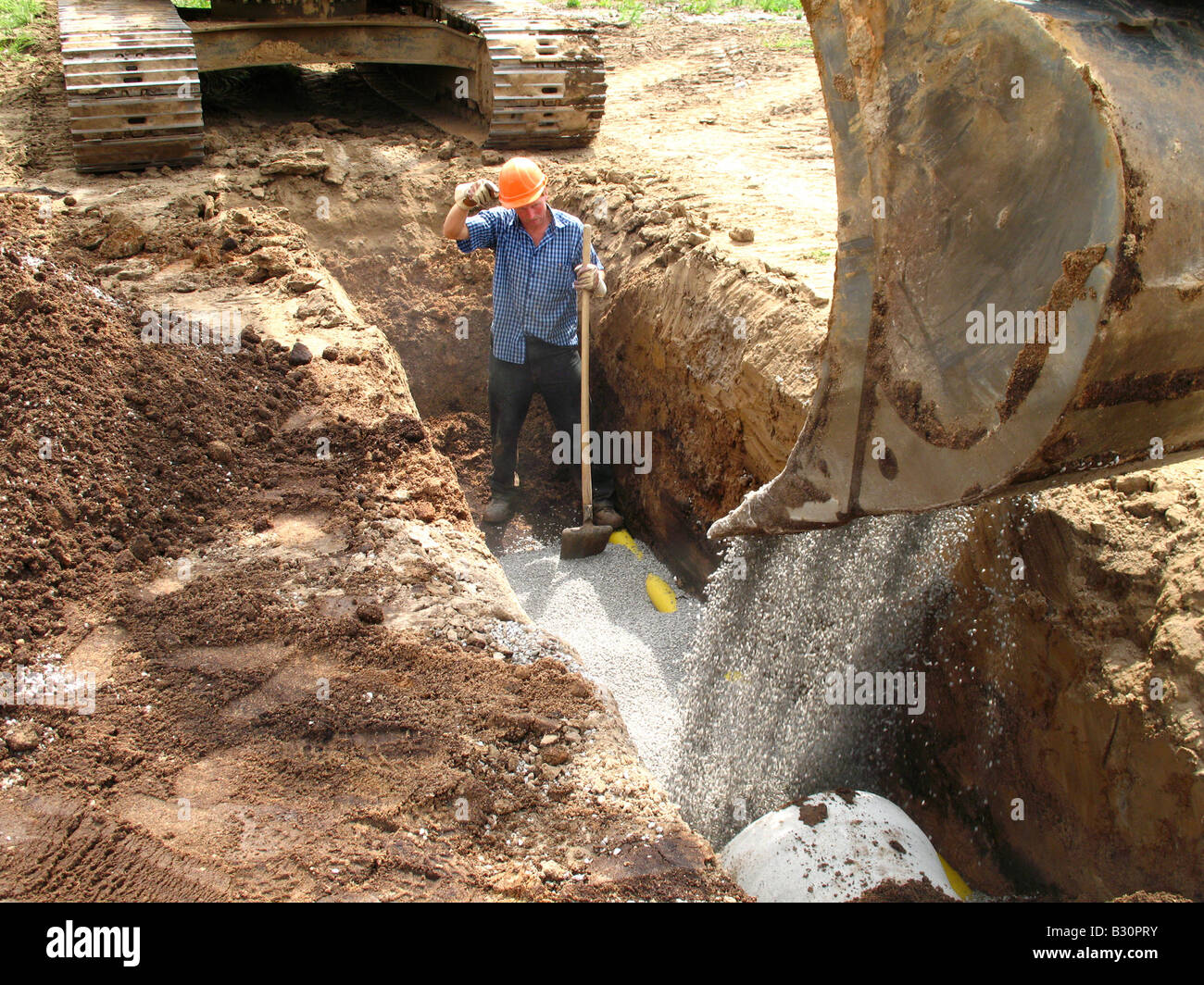 Building worker in excavation Stock Photo - Alamy