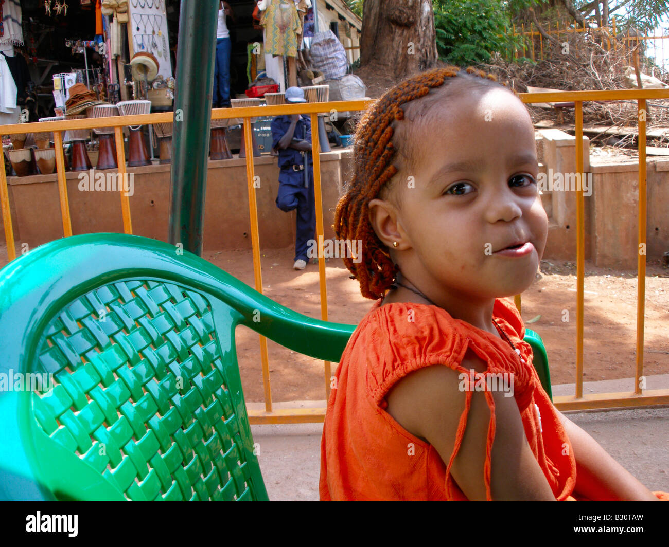 A young girl on an adult chair poses for the camera Stock Photo - Alamy