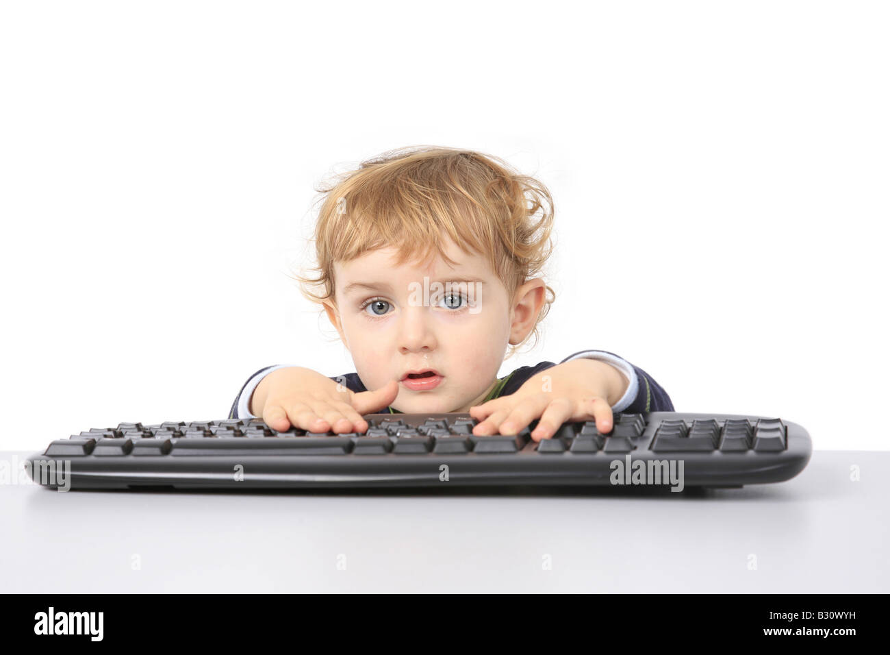 small boy with computer keyboard Stock Photo - Alamy