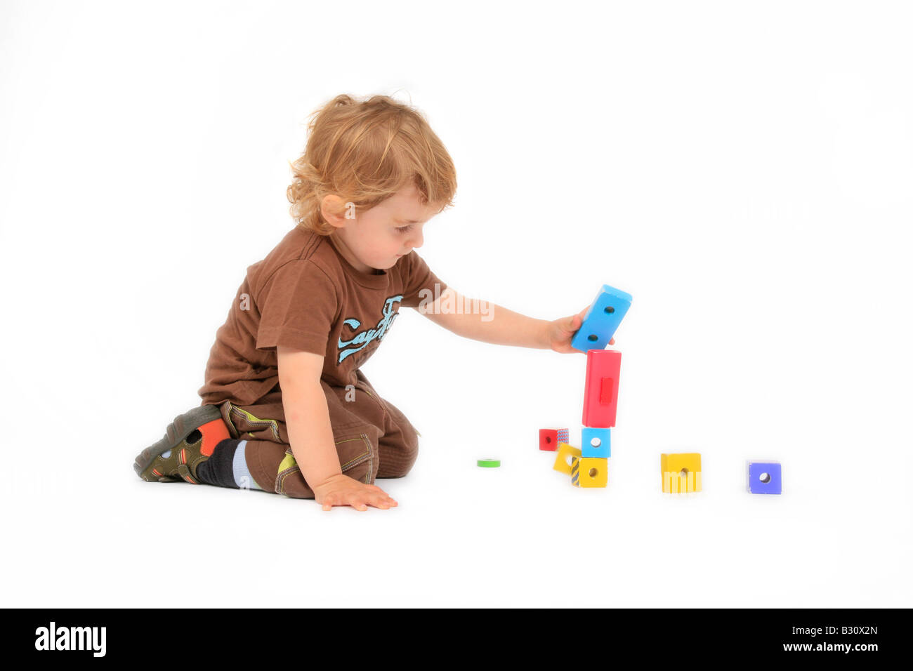 small boy builds brick tower Stock Photo - Alamy