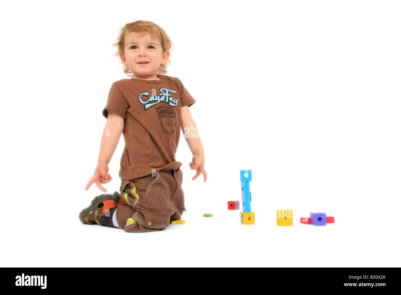 small boy builds brick tower Stock Photo - Alamy