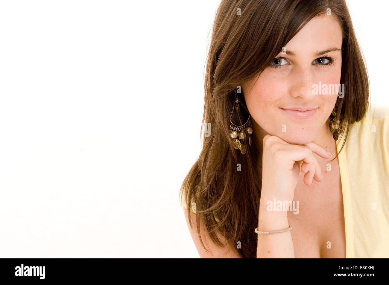 A young woman gives a slight smile Stock Photo - Alamy