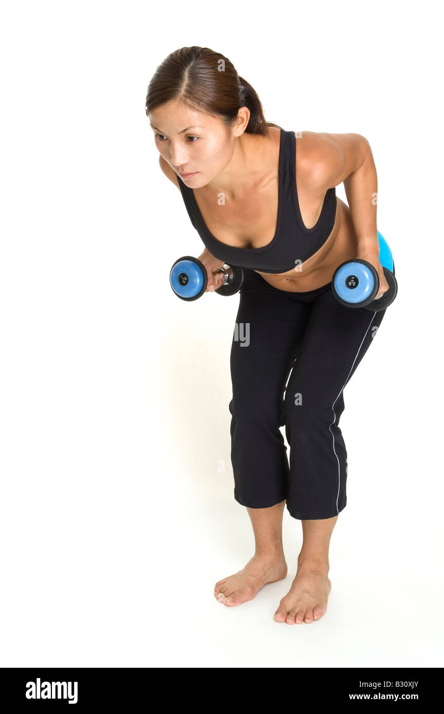 A female fitness instructor demonstrates the finishing position of bent ...