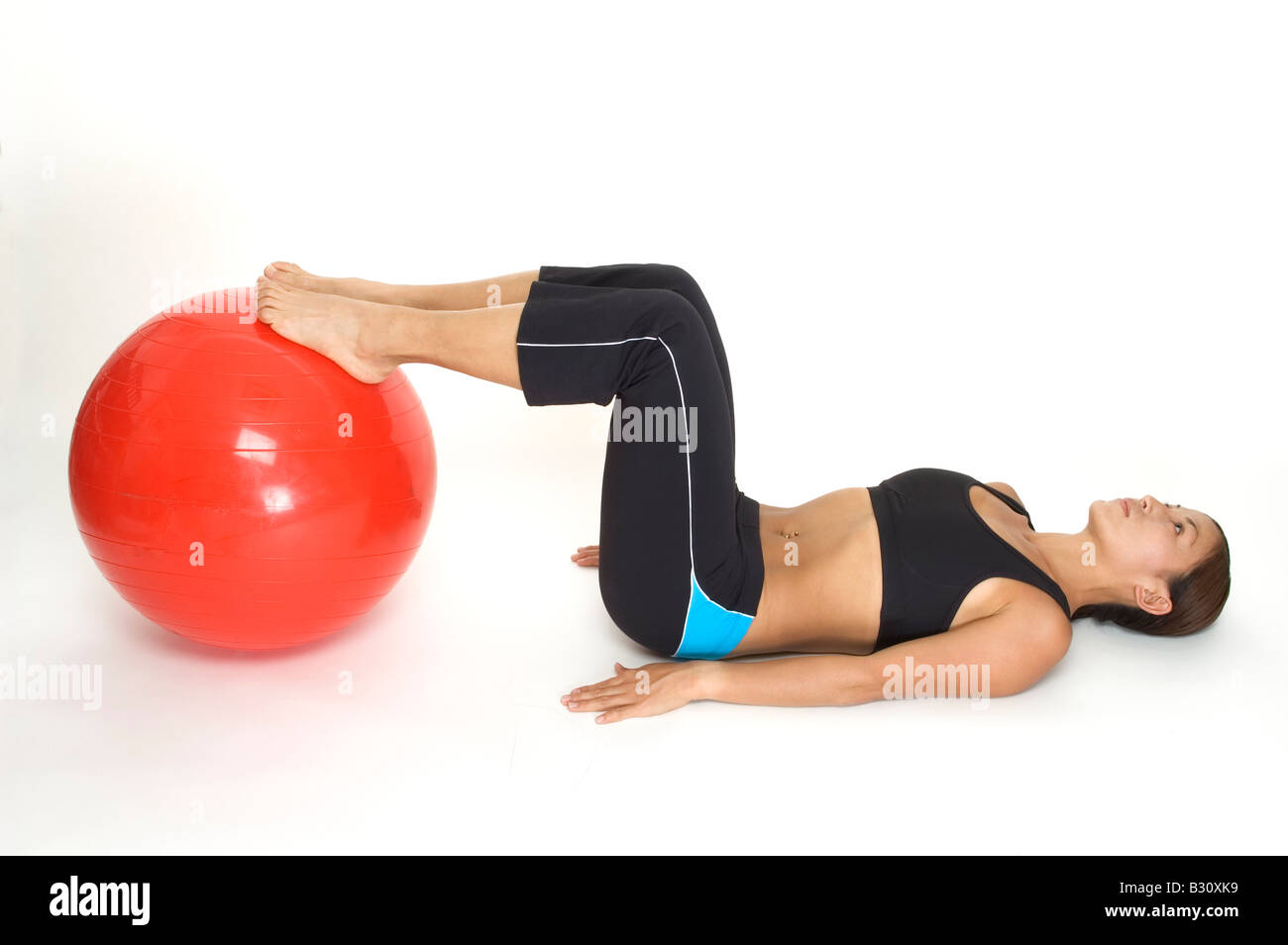 A female fitness instructor demonstrates the starting position of the ...