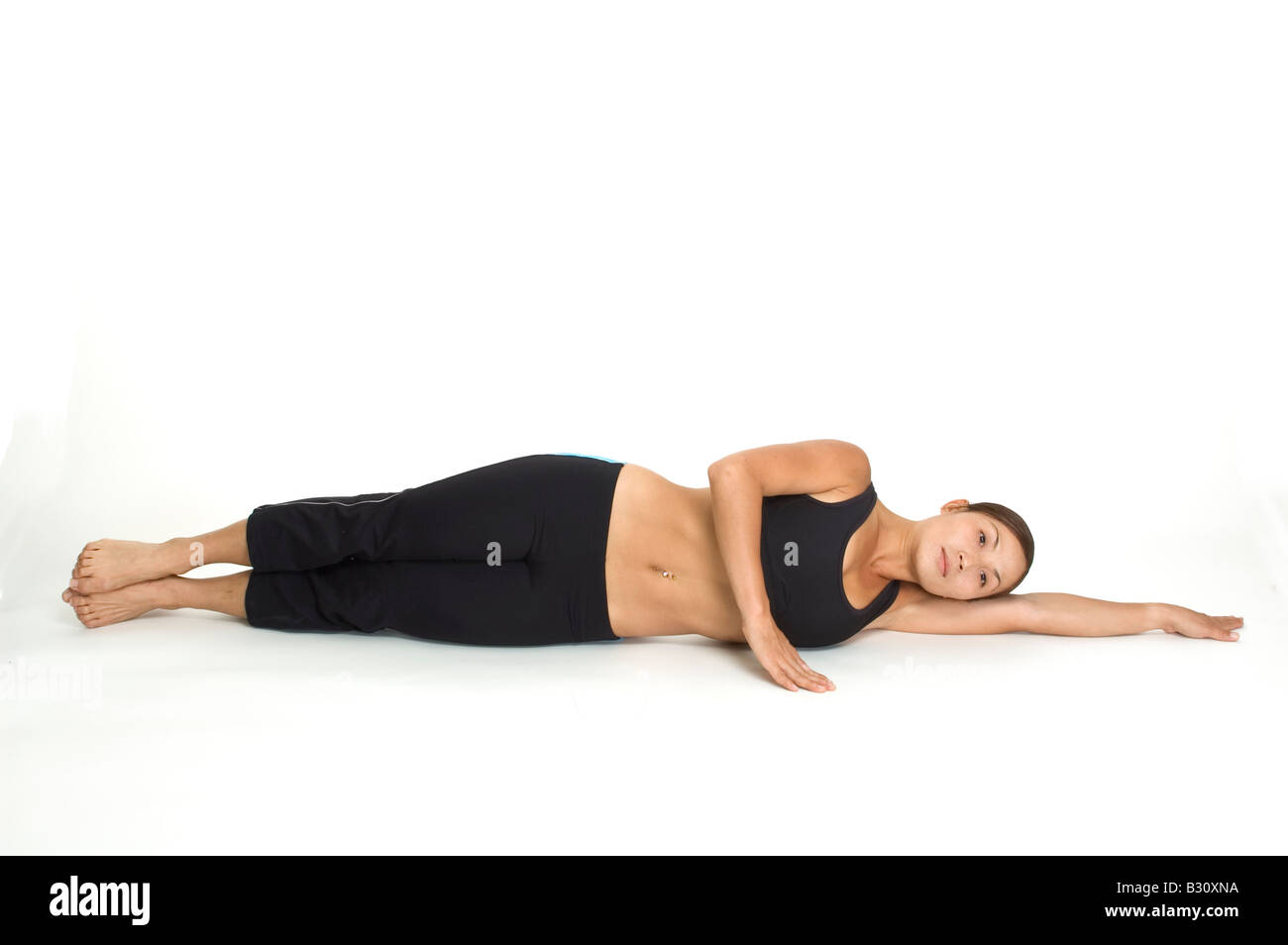 A female fitness instructor demonstrates the starting position of the ...