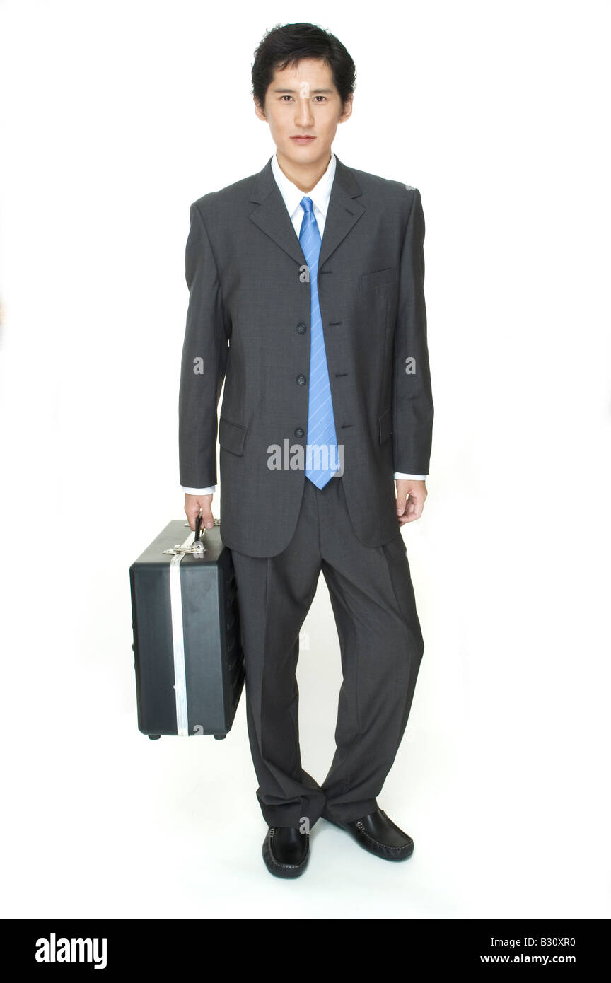 An asian businessman carries a hard case Stock Photo - Alamy