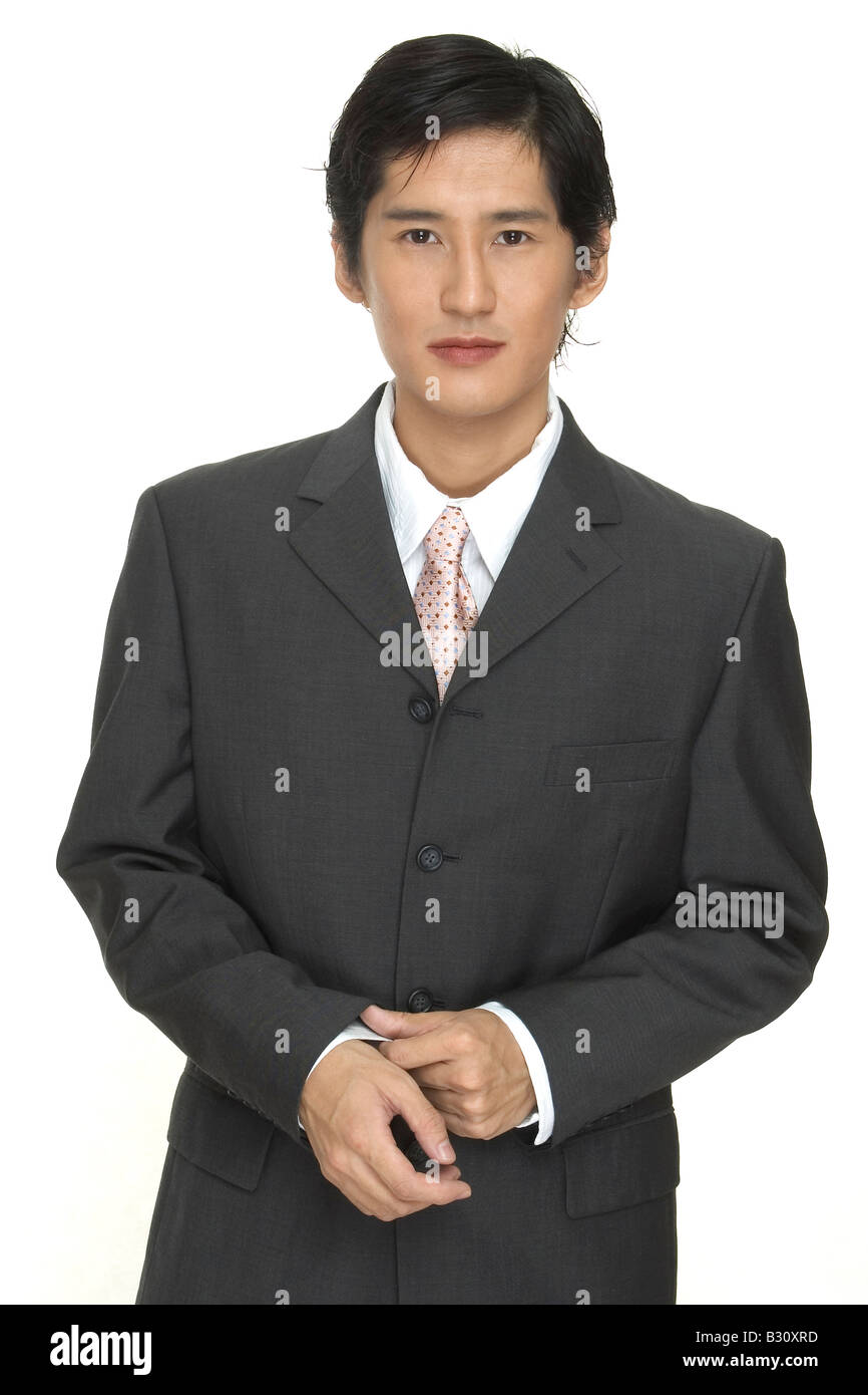 An asian businessman in a smart grey suit with white shirt and pink tie ...