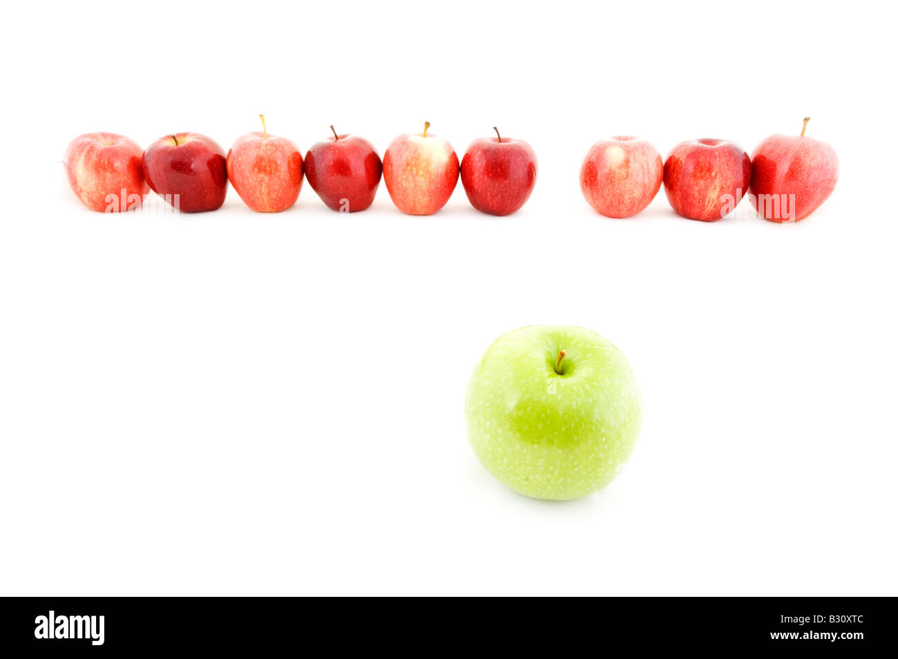 A green apple stands out from a line of red apples Stock Photo - Alamy