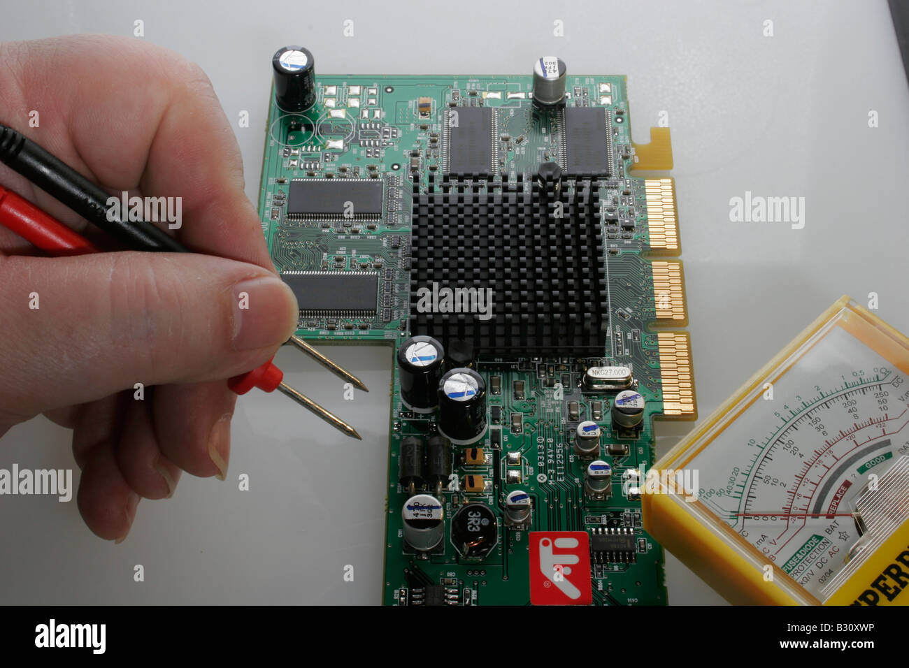 Technician checking a computer graphics board Stock Photo - Alamy