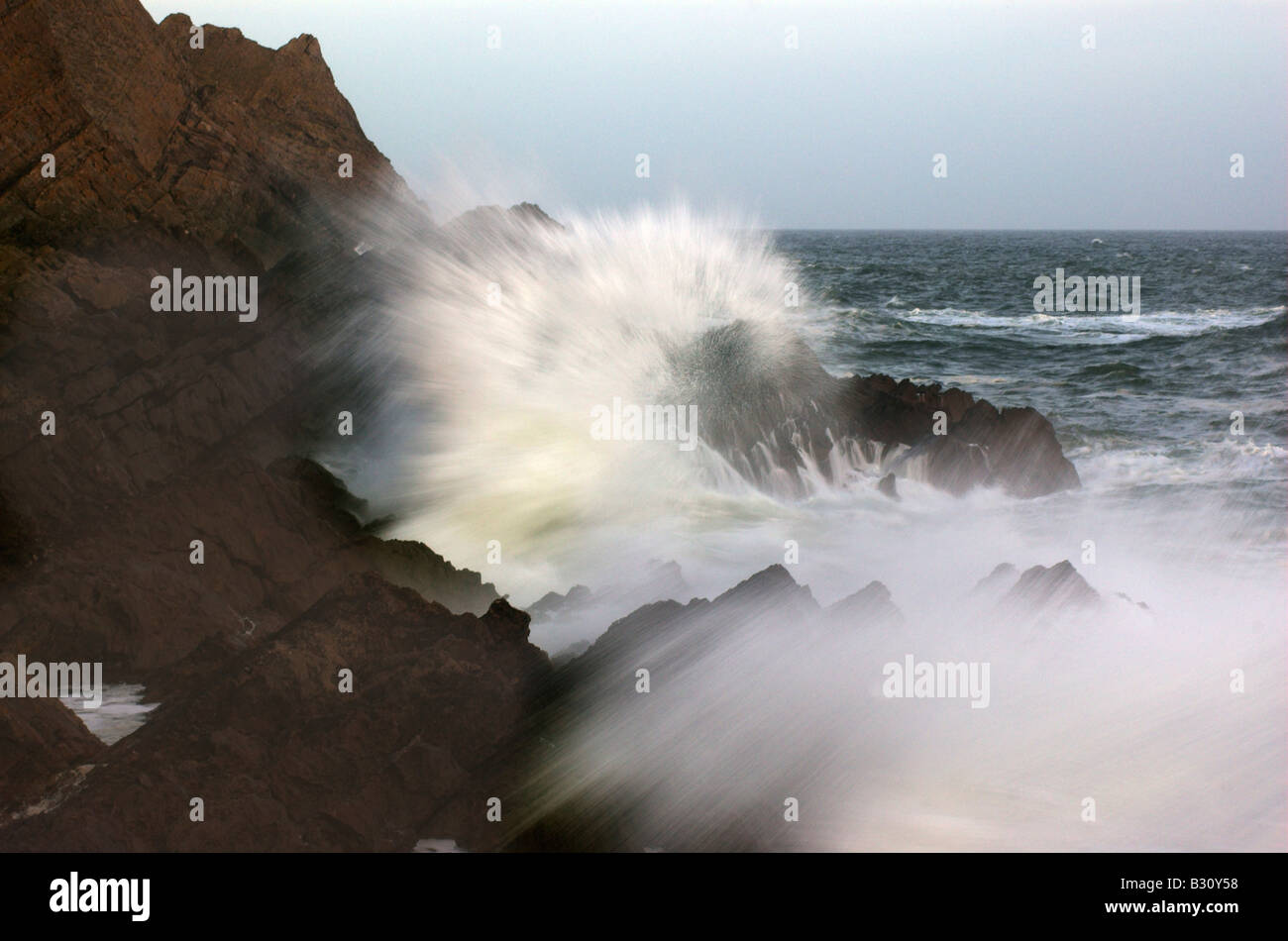 Waves breaking over rocks on the Gower peninsula Stock Photo - Alamy