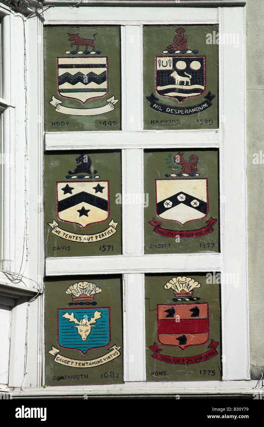 A close up of family crests on a wall above the post office in ...