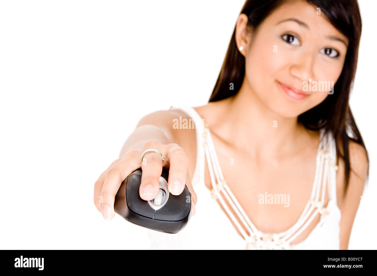 A young asian woman using a computer mouse and smiling (focus on mouse ...