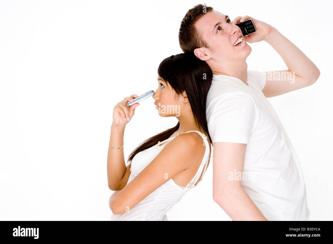 A young woman looks left out as her boyfriend talks on the phone Stock ...