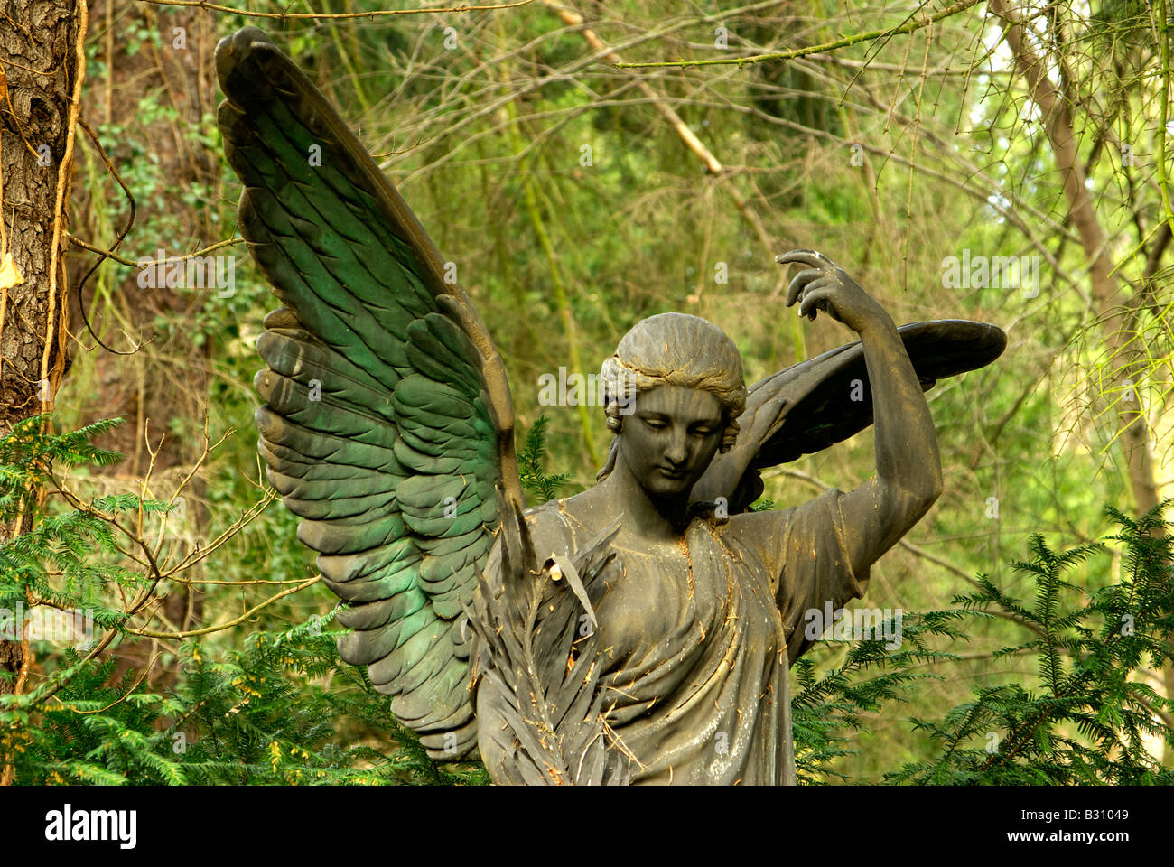 angel sculpture with spread wings and raised left hand Stock Photo - Alamy