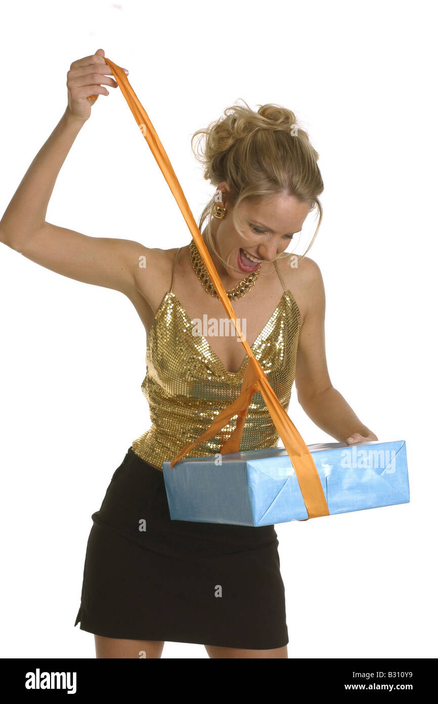 young woman clad in a party dress packing out a gift Stock Photo - Alamy