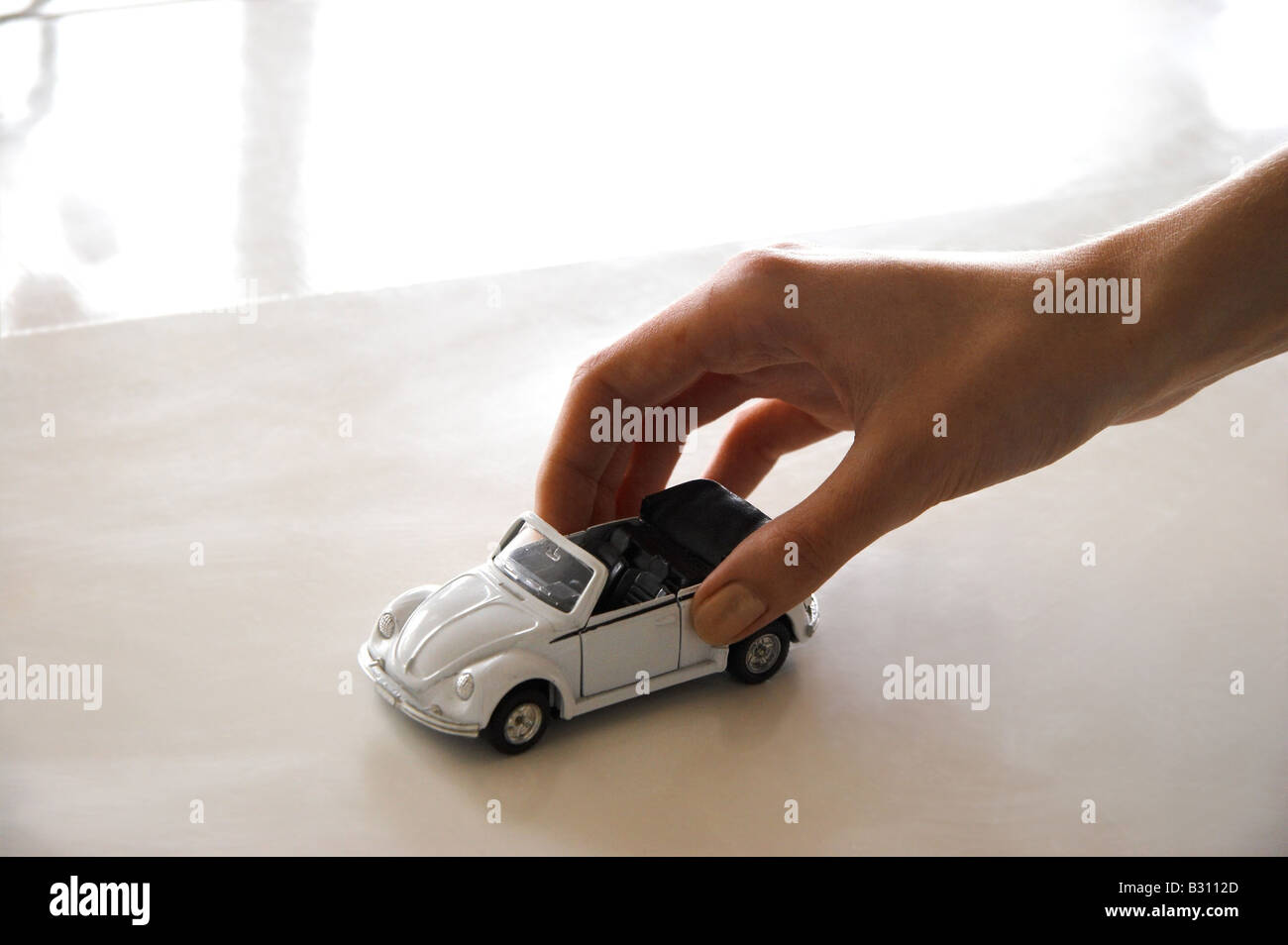 a midget-car, VW Beetle cabriolet, and a hand Stock Photo - Alamy
