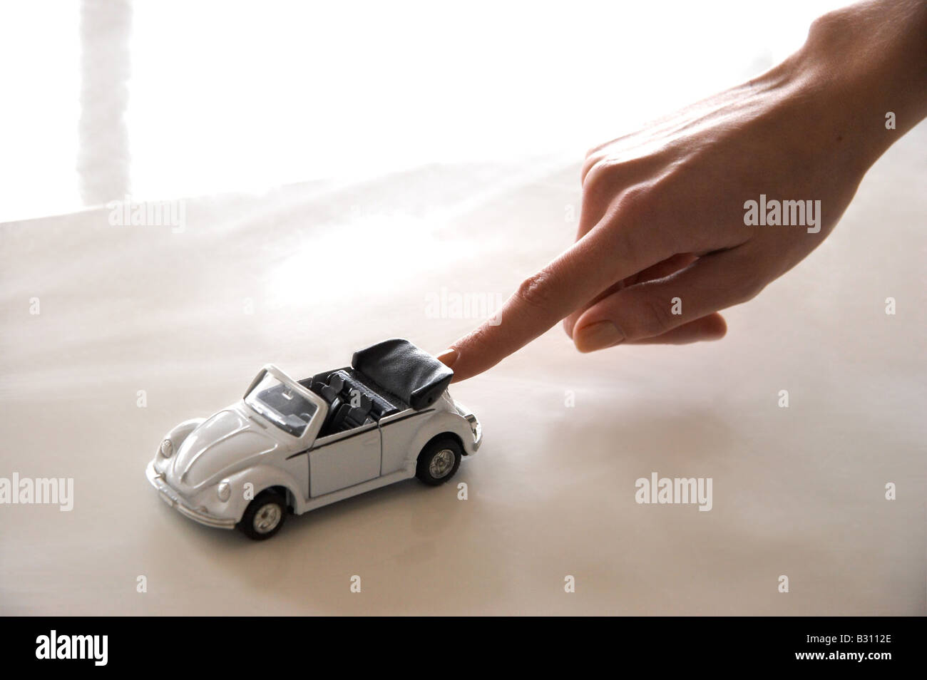 a hand pointing at a midget-car, VW Beetle cabriolet Stock Photo - Alamy