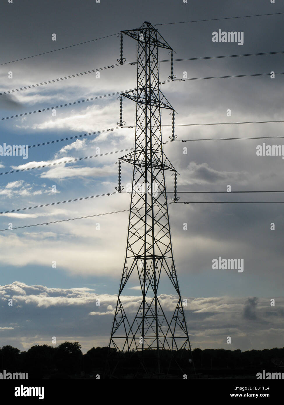Electricity pylon with storm clouds and blue sky background Stock Photo ...