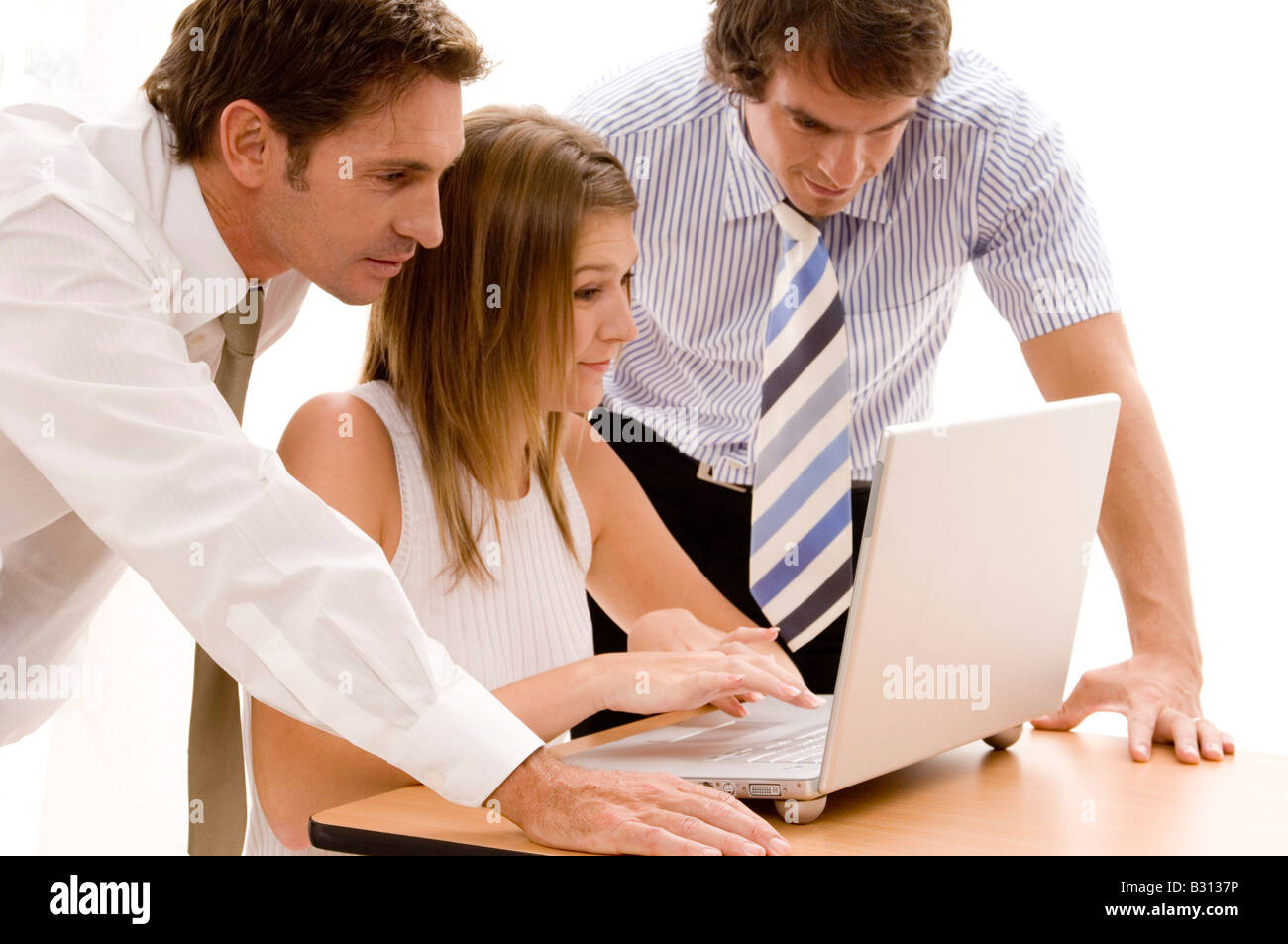 A business team working on a laptop computer Stock Photo - Alamy