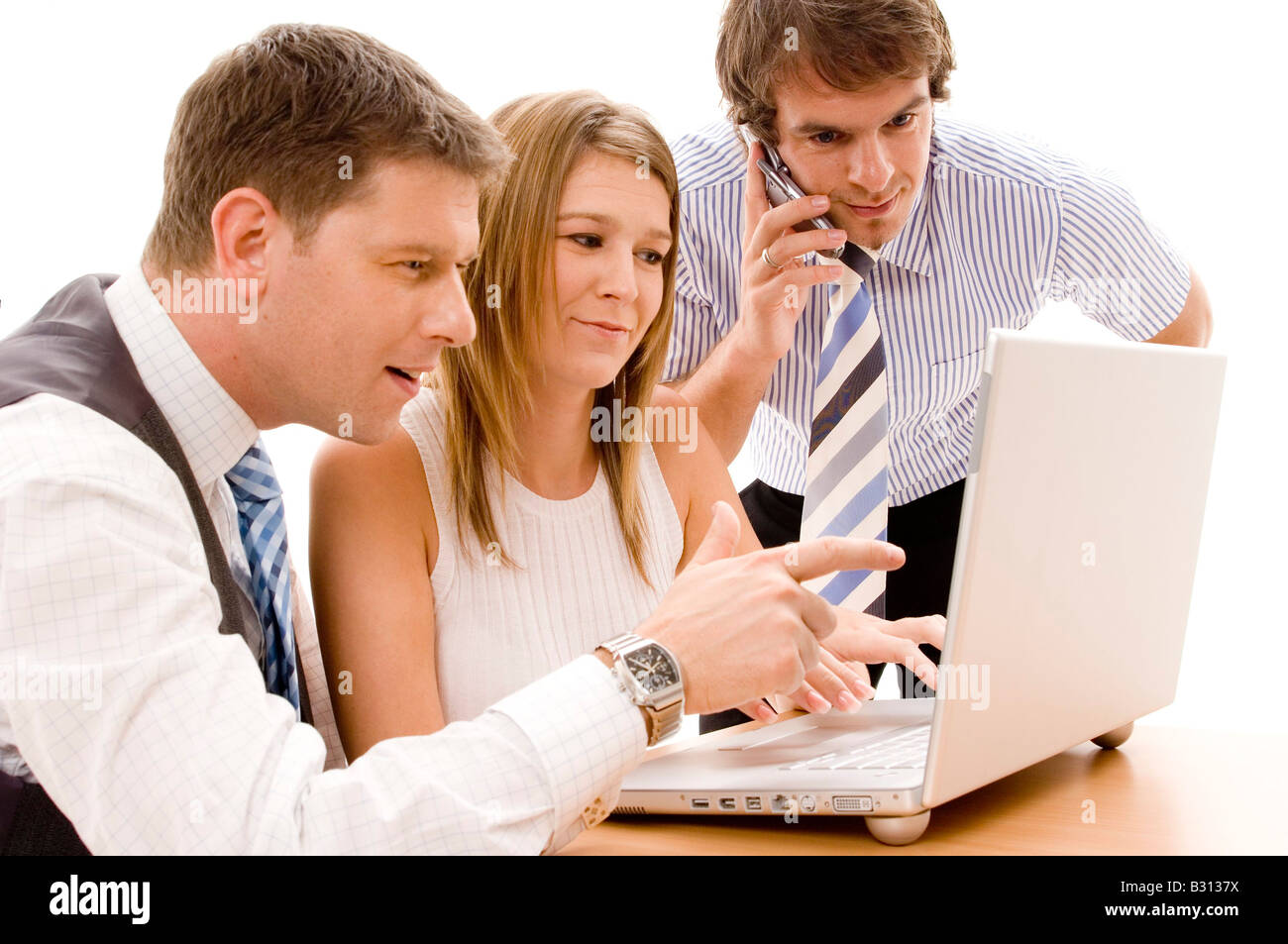 A business team of three works on a laptop computer Stock Photo - Alamy