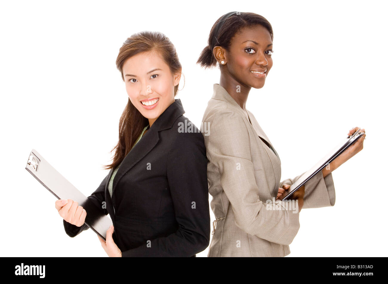 two attractive young business women with clipboards on white background ...