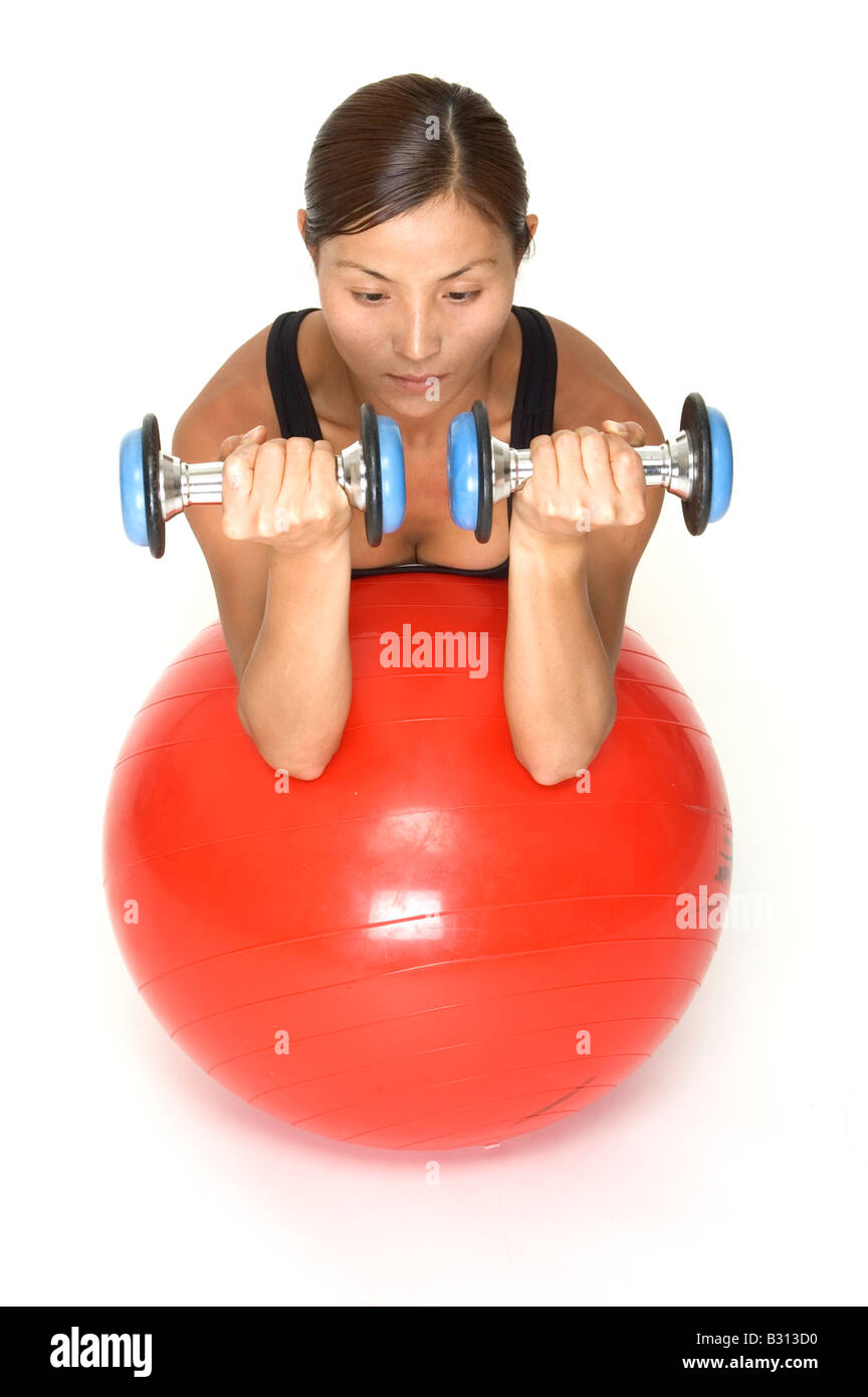 A female fitness instructor demonstrates the finishing position of the ...